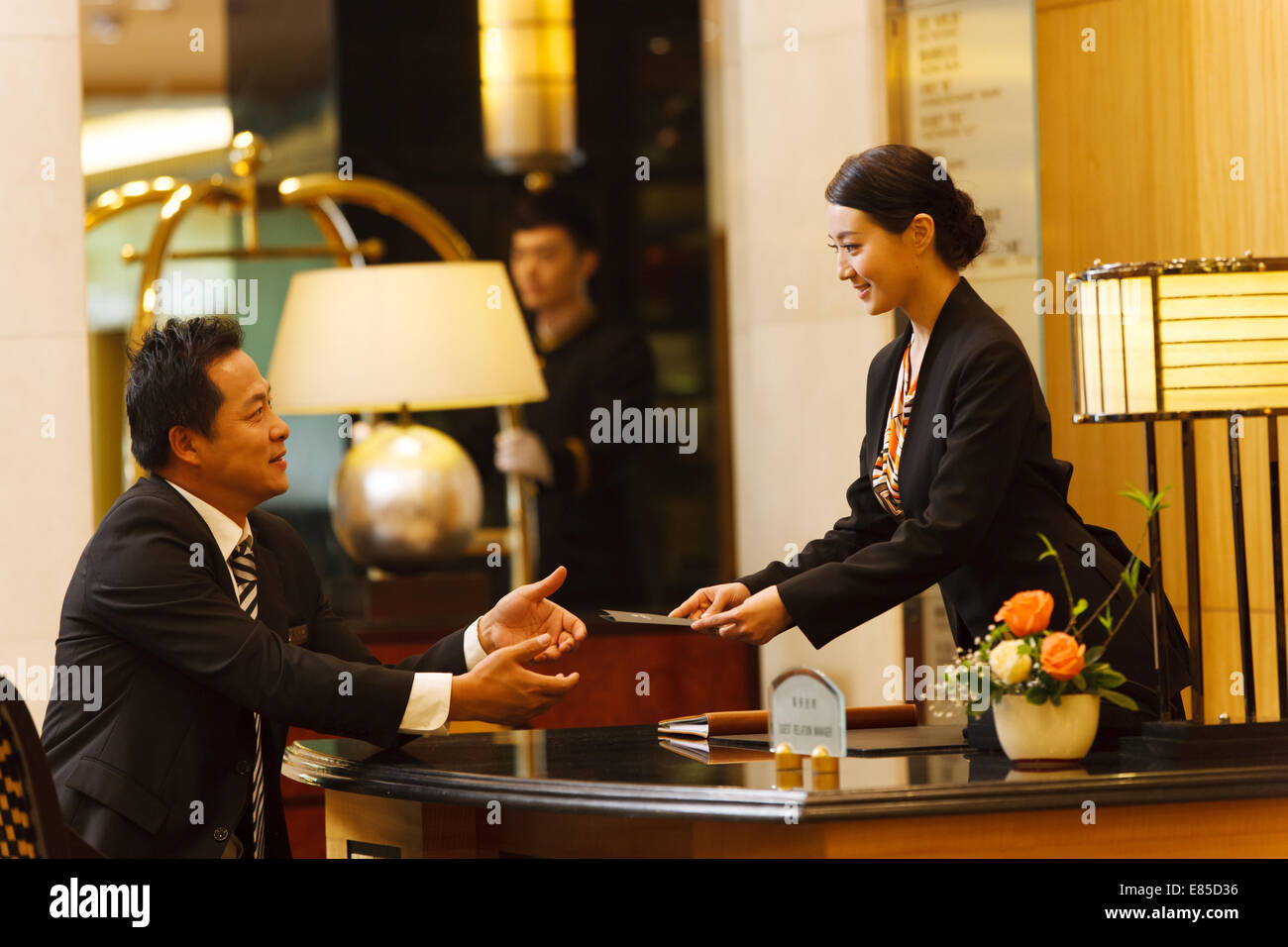 Businessman at hotel reception Stock Photo - Alamy
