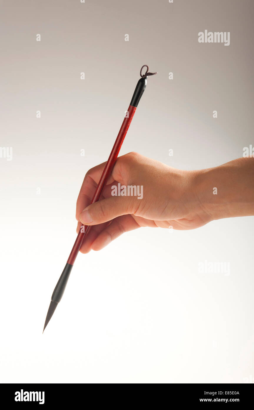 Hand holding traditional writing brush hi-res stock photography and ...