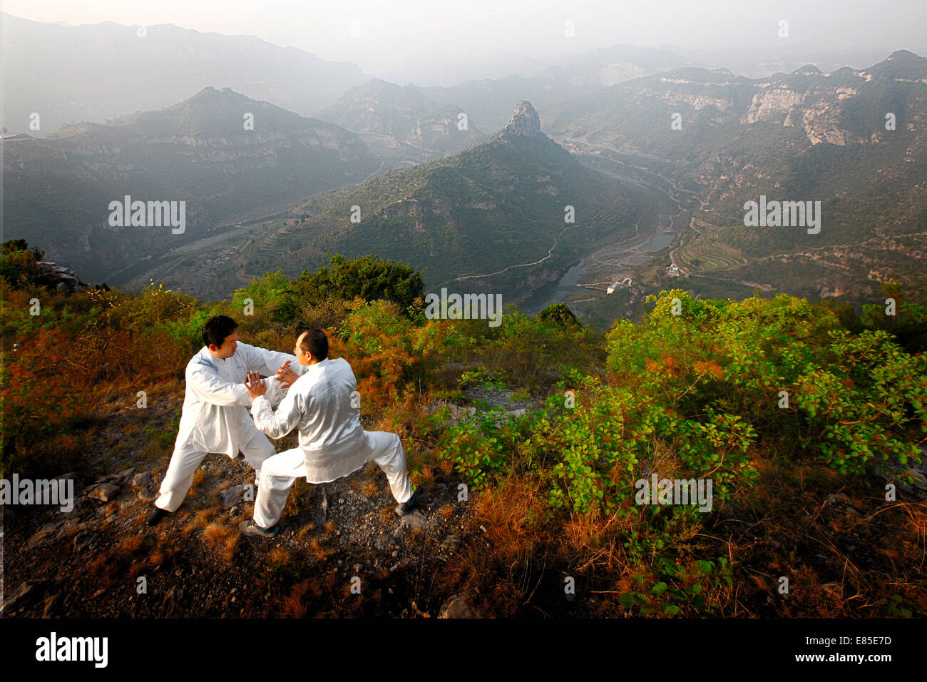 People doing exercise on hill Stock Photo - Alamy