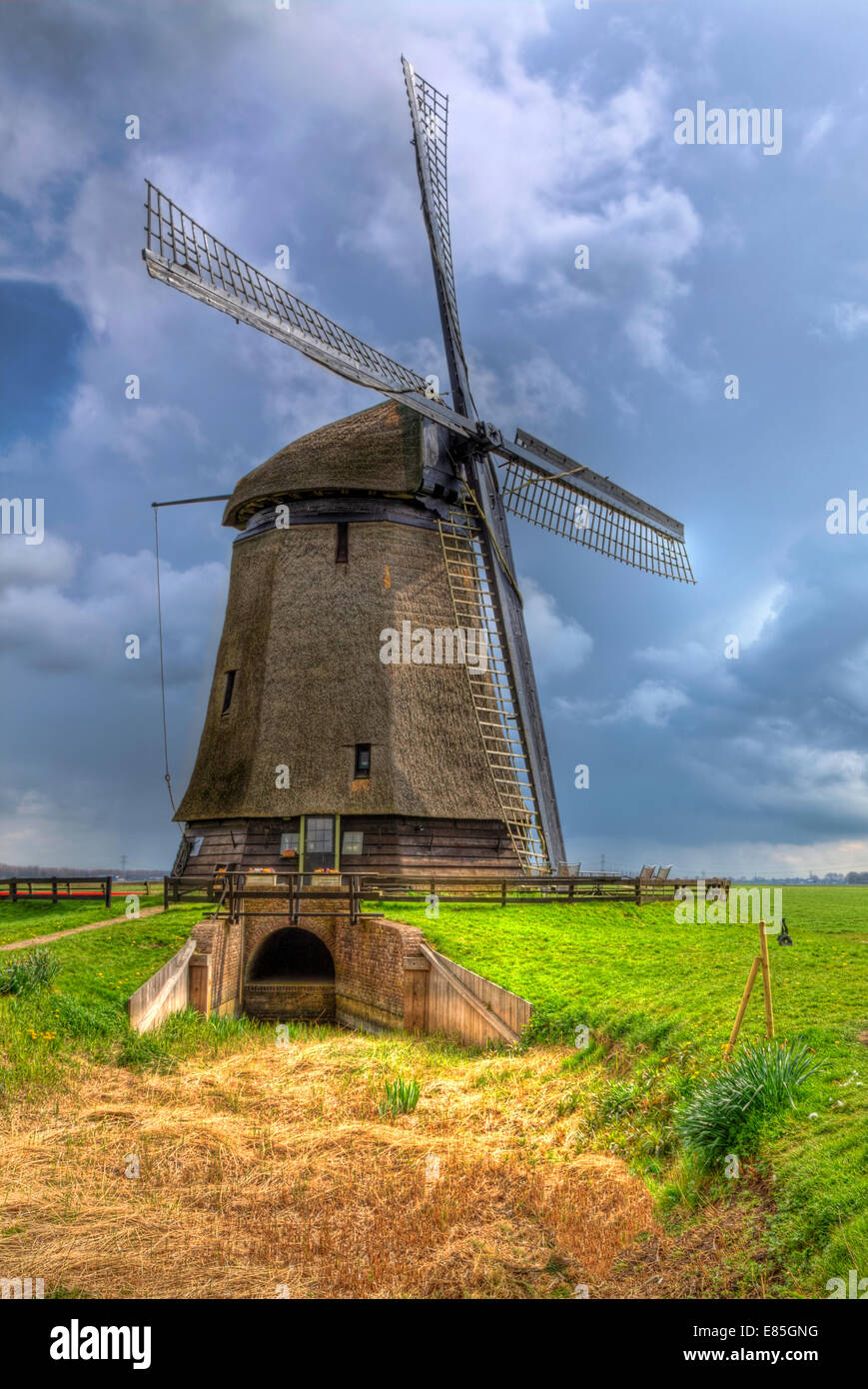 Image of a traditional Dutch windmill located in a green field during a ...