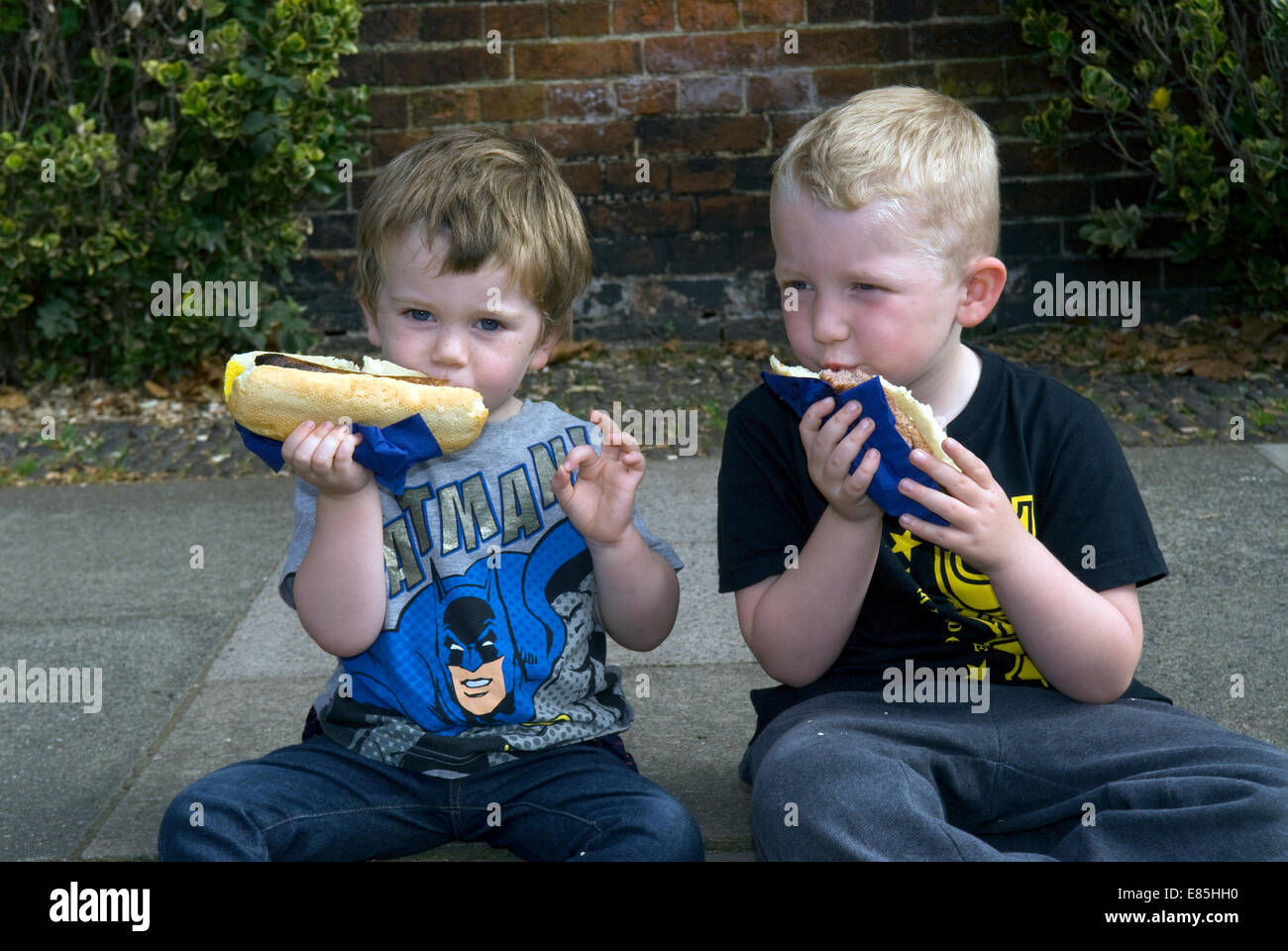 2 youngsters eating hot dogs at the Farnham Food Festival 2014, Castle ...
