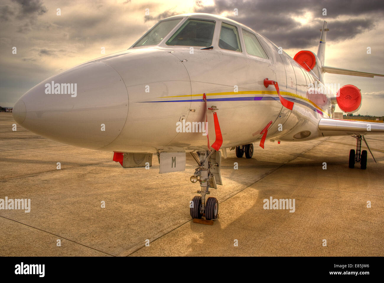 Private jet on runway with red tags Stock Photo - Alamy