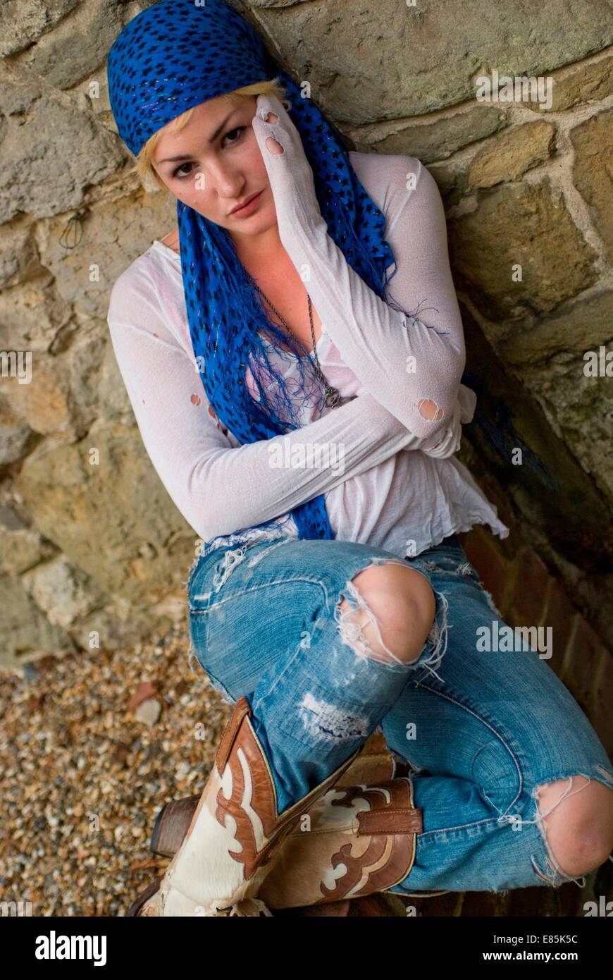 Woman in ripped clothing blue hi-res stock photography and images - Alamy