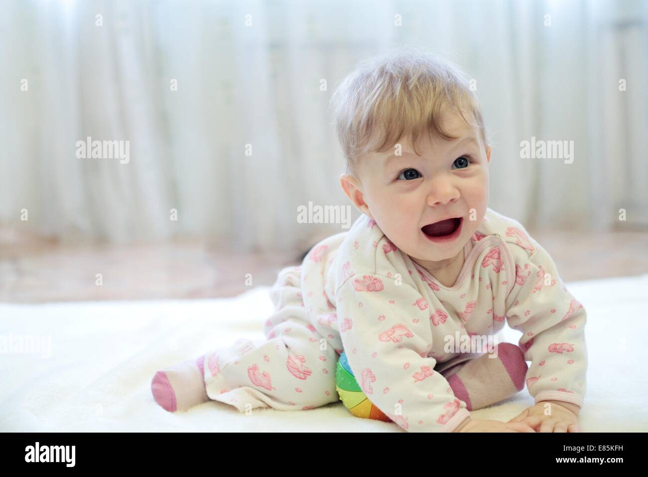 baby girl playing with smile expression indoors Stock Photo - Alamy