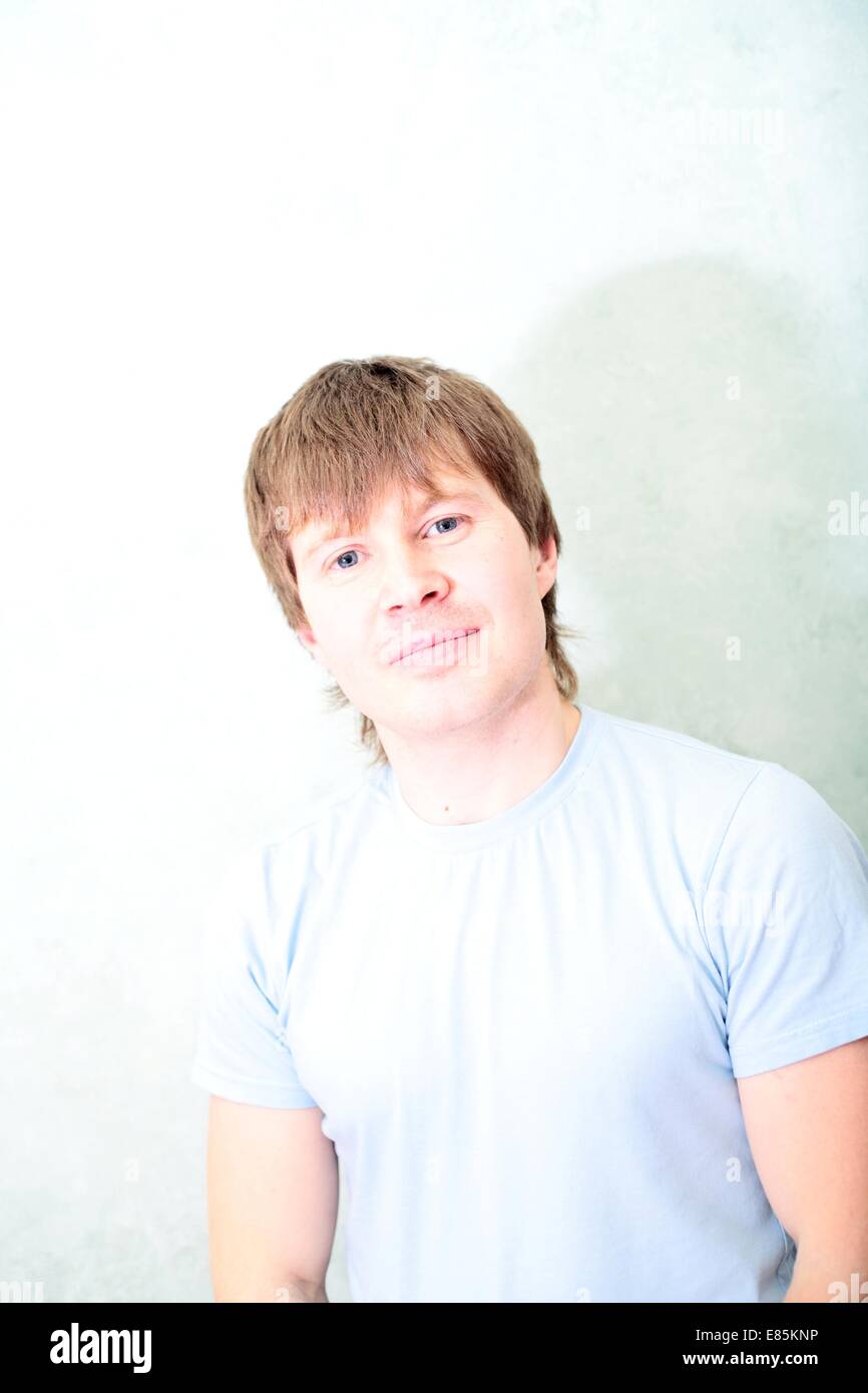 relaxed white man against of the rooms wall Stock Photo - Alamy