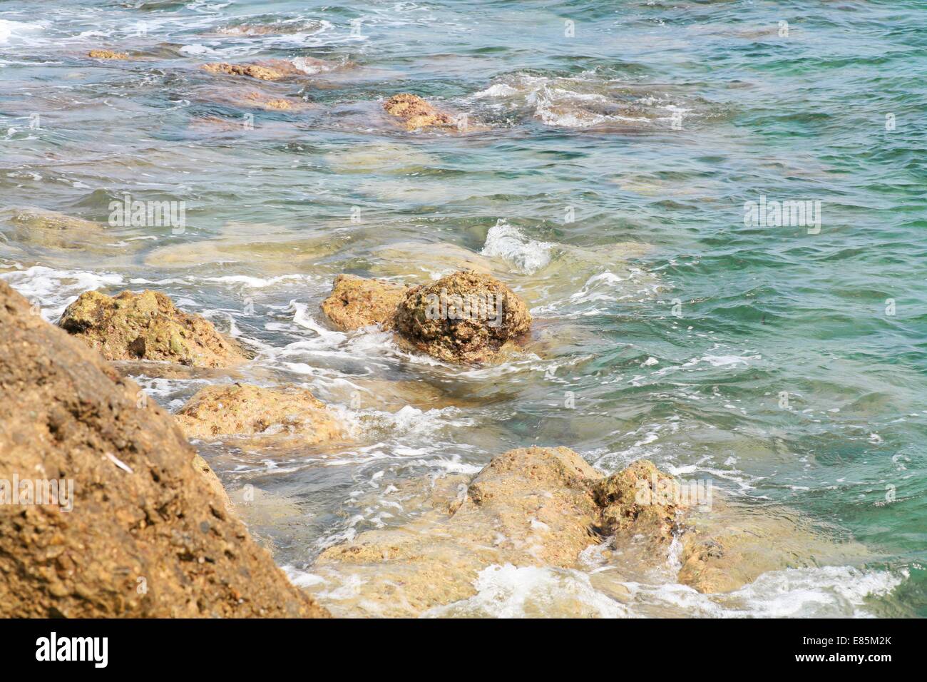 The rock on seashore with blue water (long exposure Stock Photo - Alamy