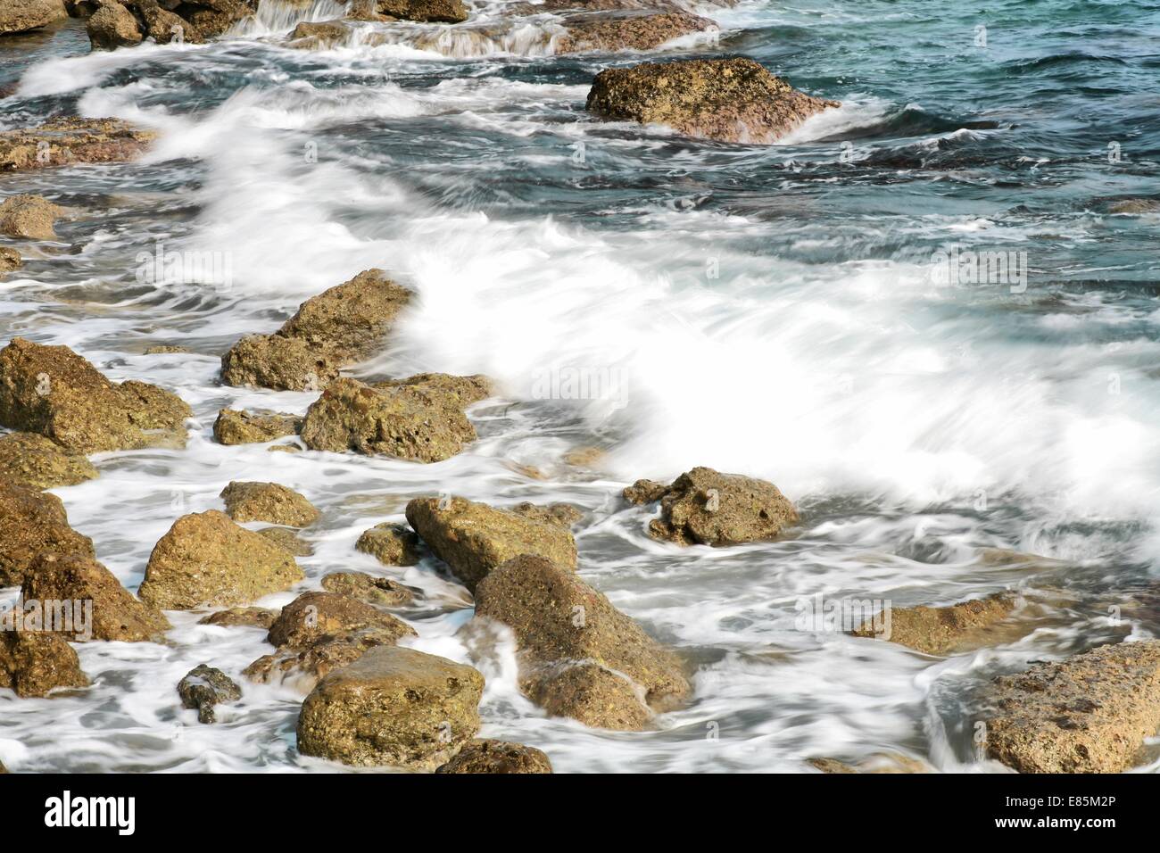 The rock on seashore with water and coming wave (HDR, long exposure ...