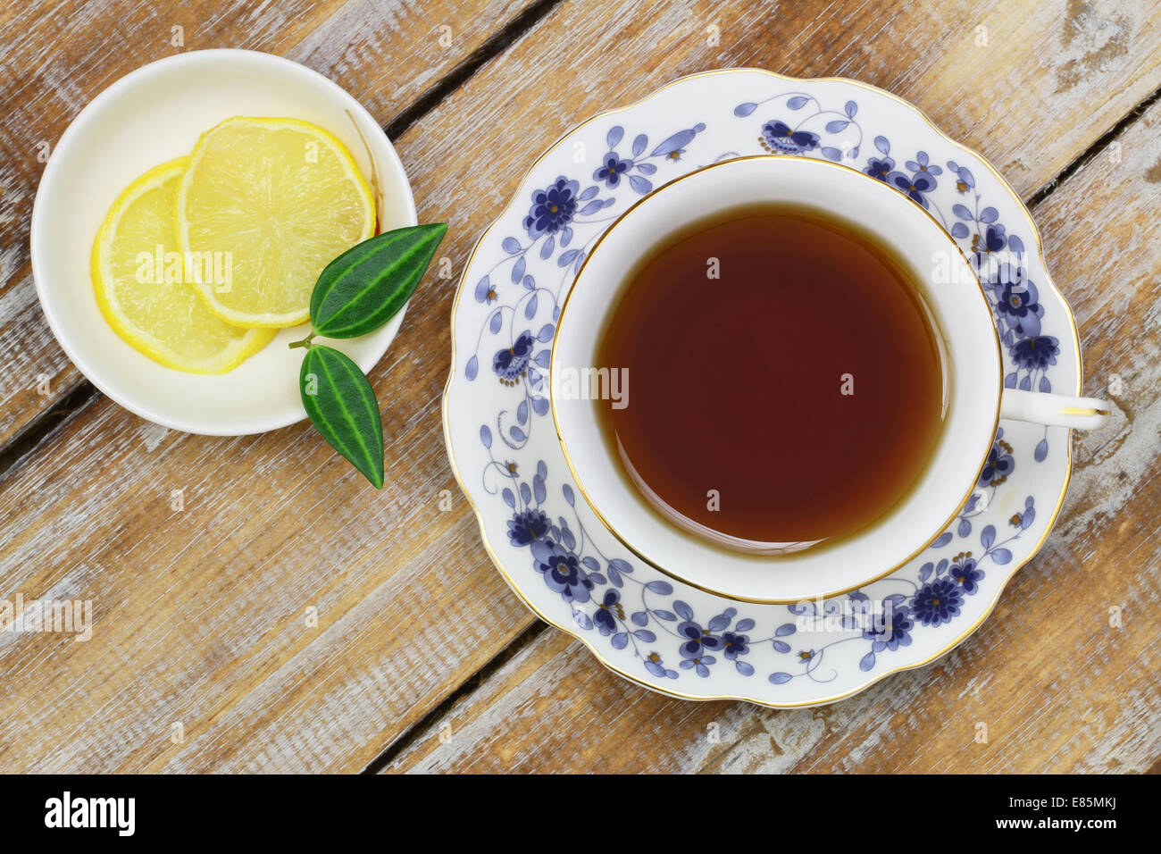 Tea in vintage cup on wooden surface Stock Photo - Alamy