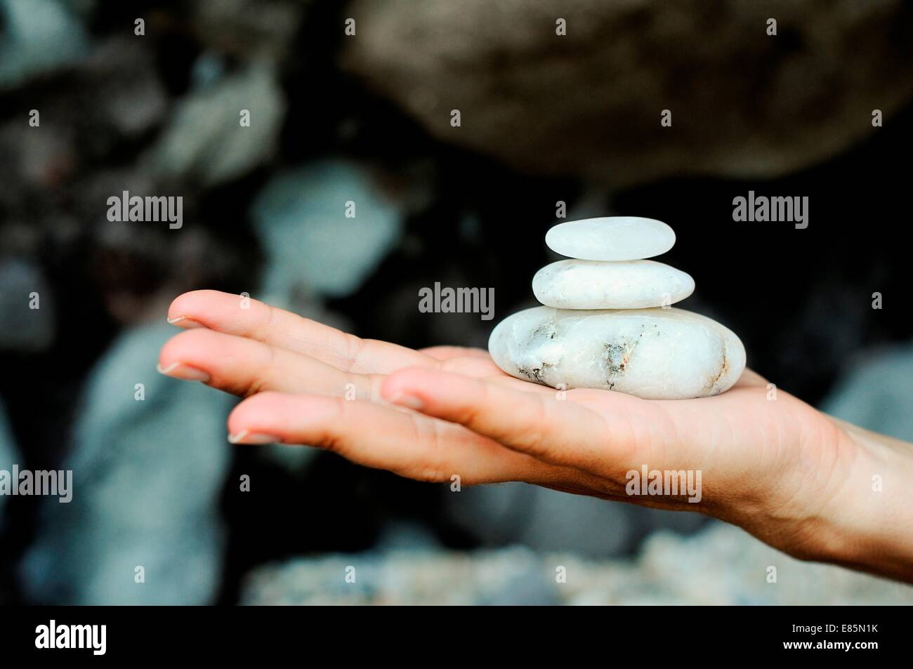 Stones on hand Stock Photo - Alamy