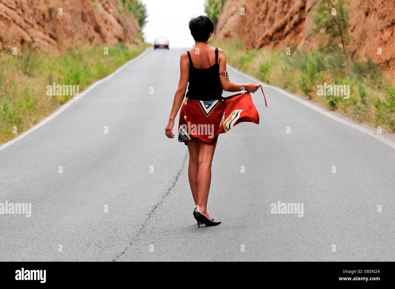 Woman on the road Stock Photo - Alamy