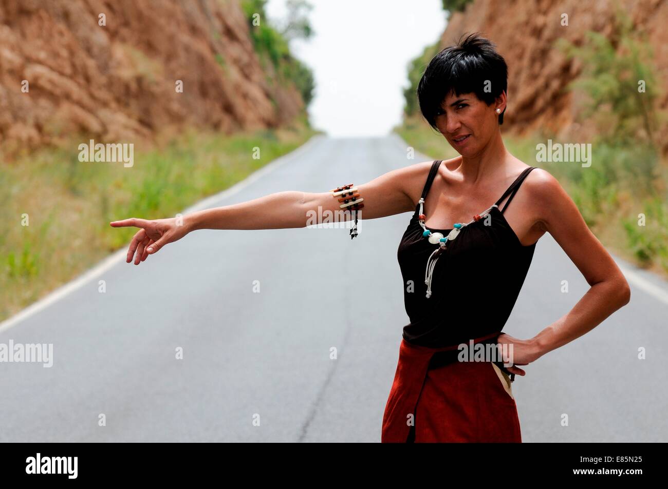 Woman on the road Stock Photo - Alamy