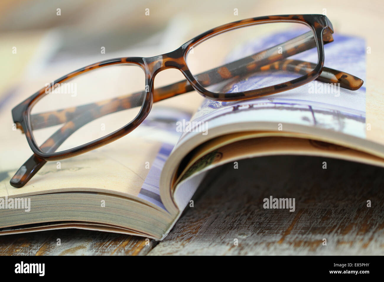 Reading glasses on open book Stock Photo - Alamy