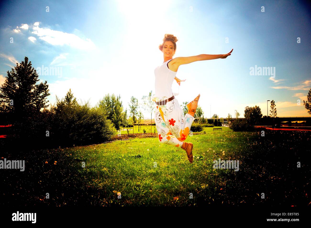 A retro style photograph of a woman dancing in a garden Stock Photo - Alamy