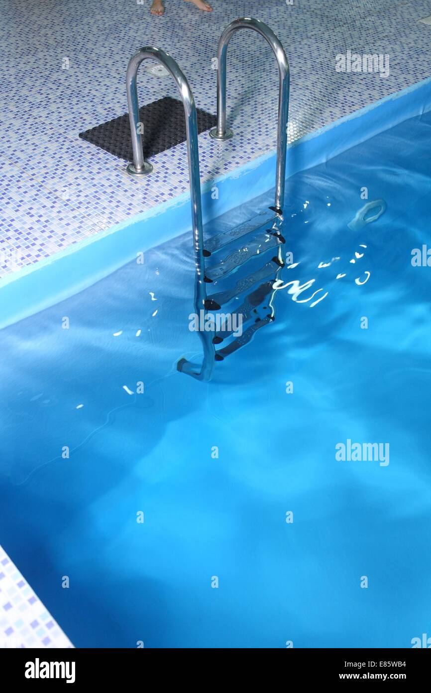 Swimming pool with blue water at hotel close up Stock Photo - Alamy