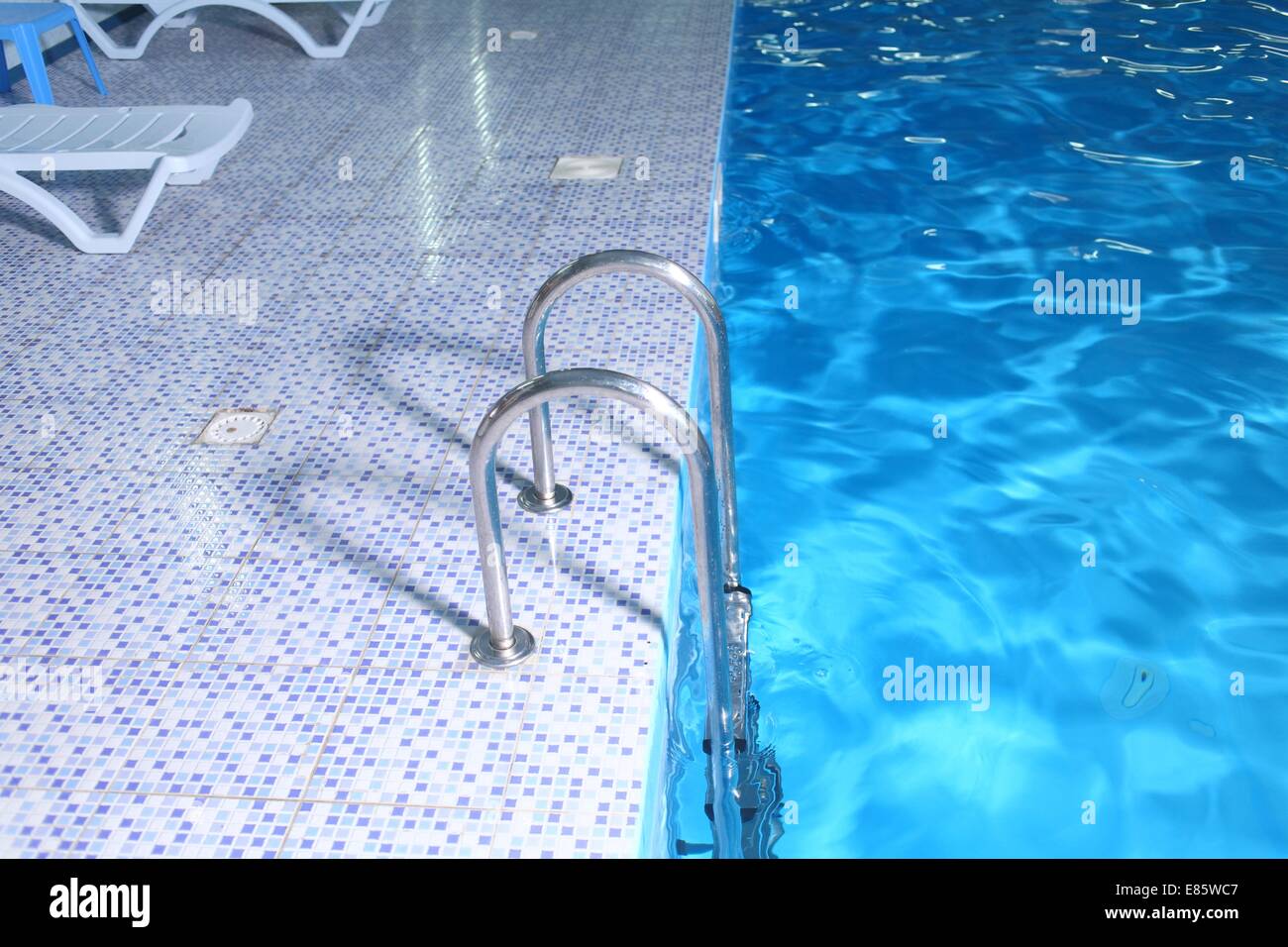 Swimming pool with blue water at hotel close up Stock Photo - Alamy