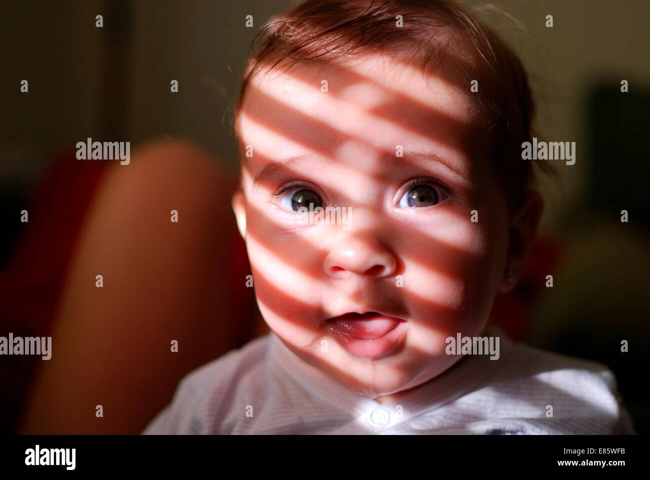 Baby with shadows across it's face Stock Photo - Alamy