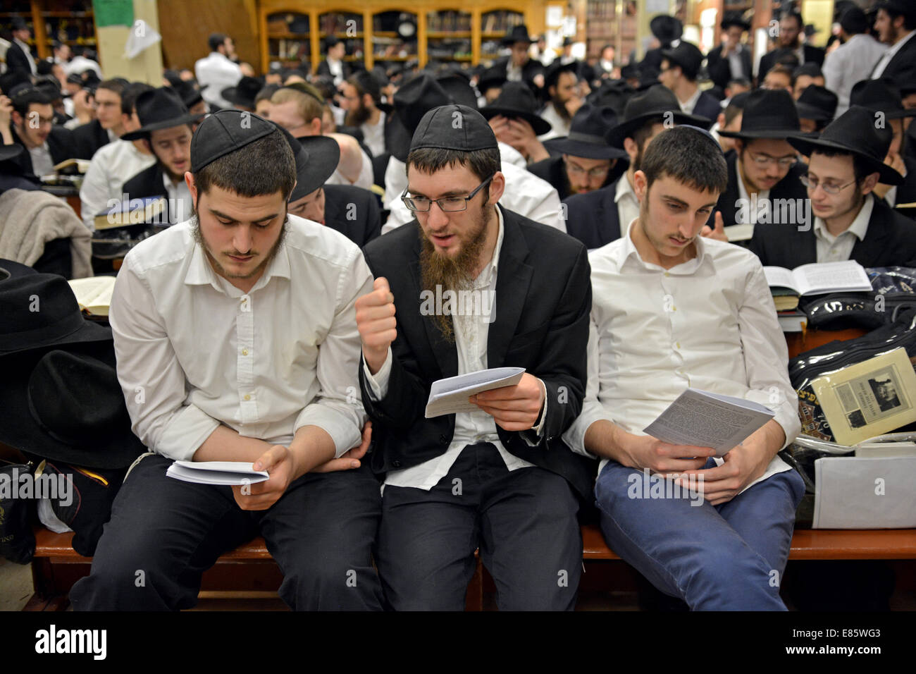 A group of religious Jewish boys studying together at a synagogue in ...