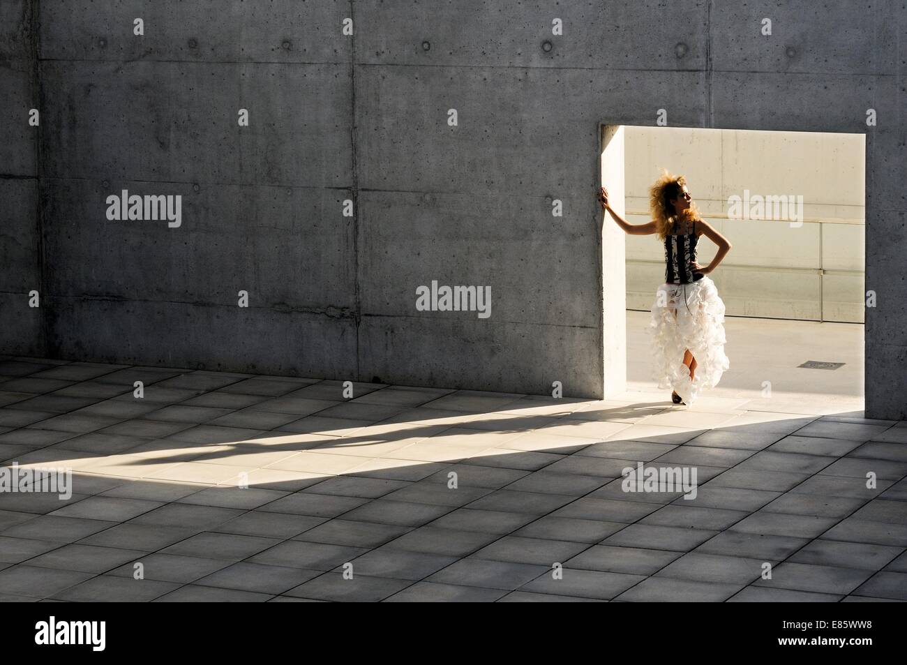 Woman standing in a doorway casting a shadow Stock Photo - Alamy