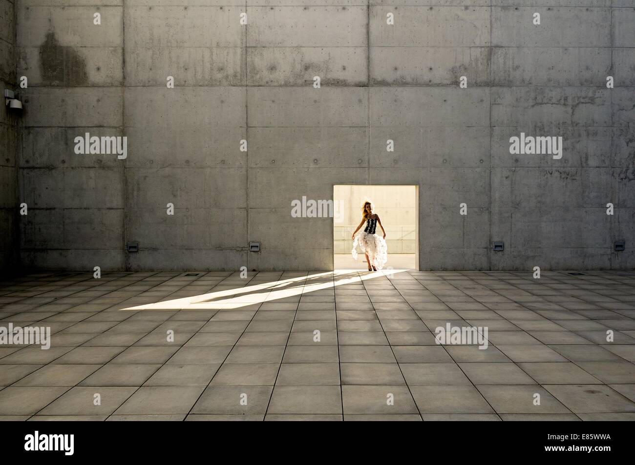 Women in doorway light shadow hi-res stock photography and images - Alamy