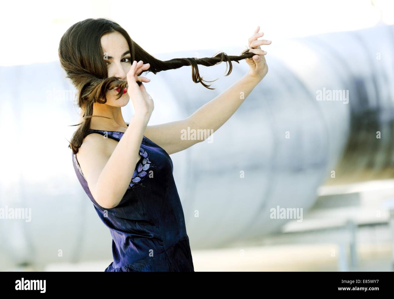 Woman playing with her hair Stock Photo - Alamy