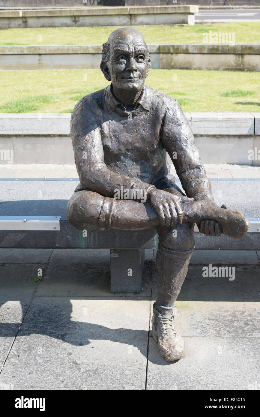 A statue of a walker sitting on a bench at the finish line of the West ...