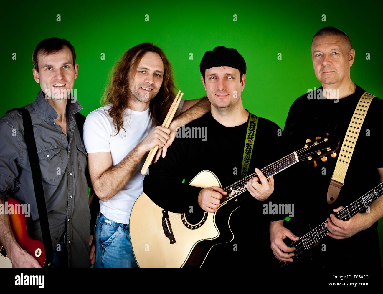 Musical group of artists on a green background Stock Photo - Alamy