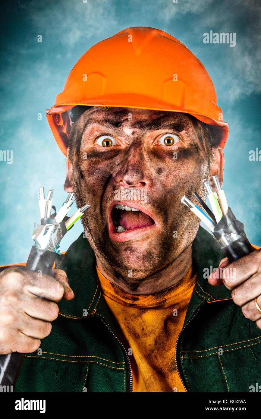 Electric shock sees a shocked electrician man Stock Photo - Alamy