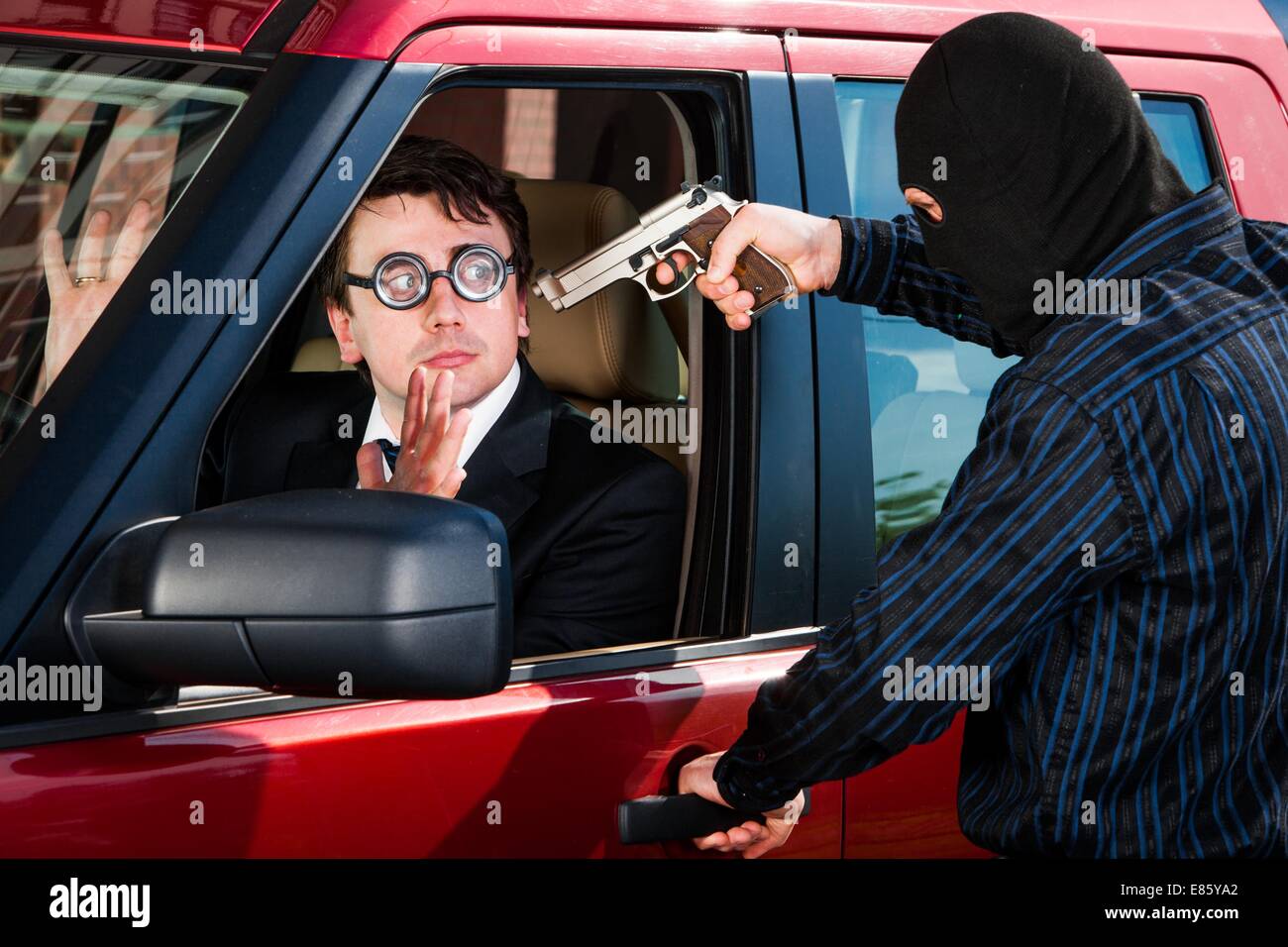 Robbery of the businessman in its car Stock Photo - Alamy