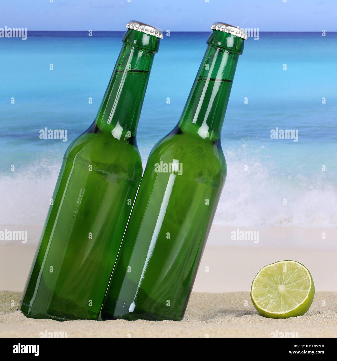 Beer bottles on the beach in sand and sea while on vacation Stock Photo ...