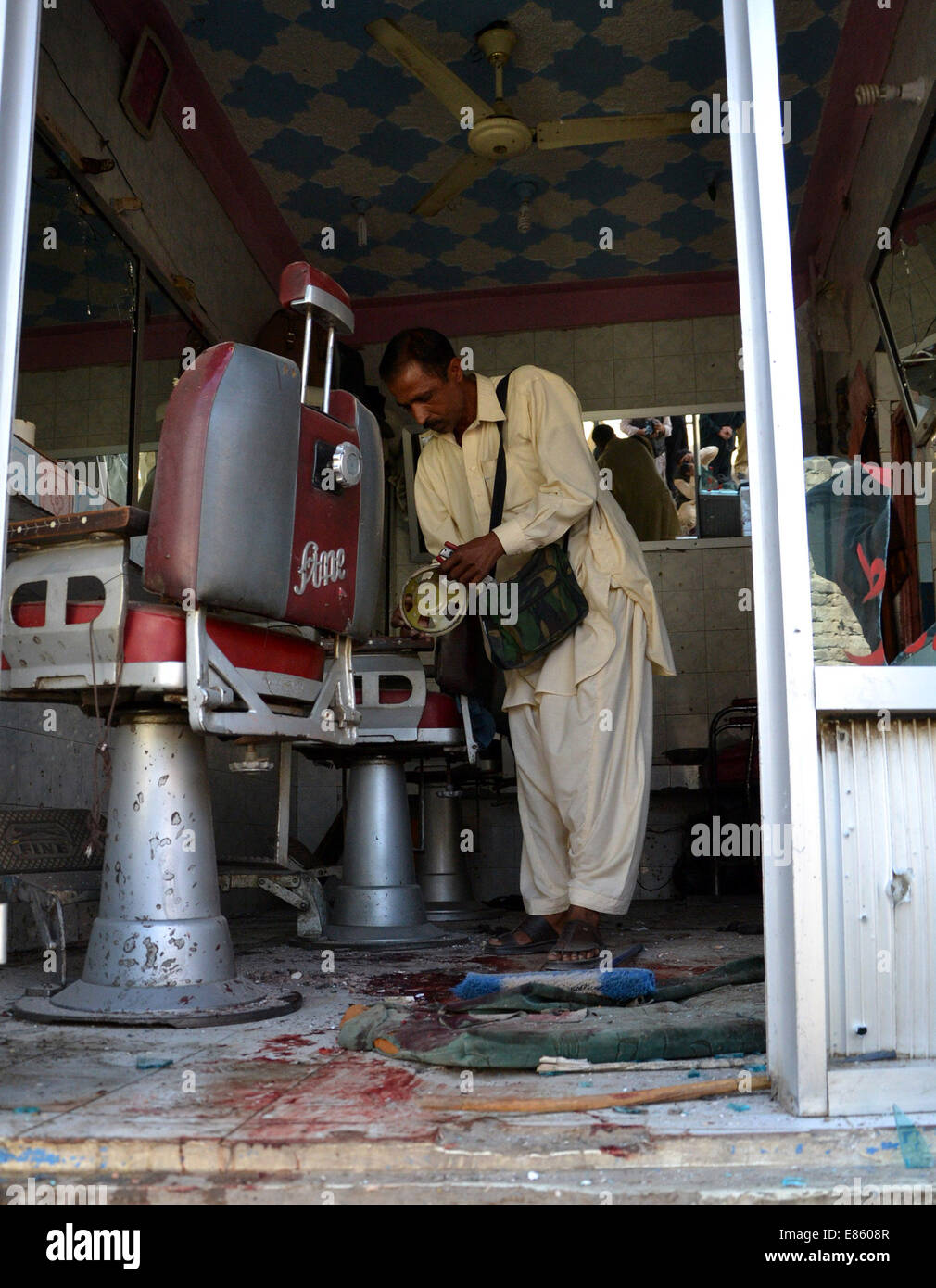 Quetta, Pakistan. 1st Oct, 2014. A policeman examines the blast site in ...