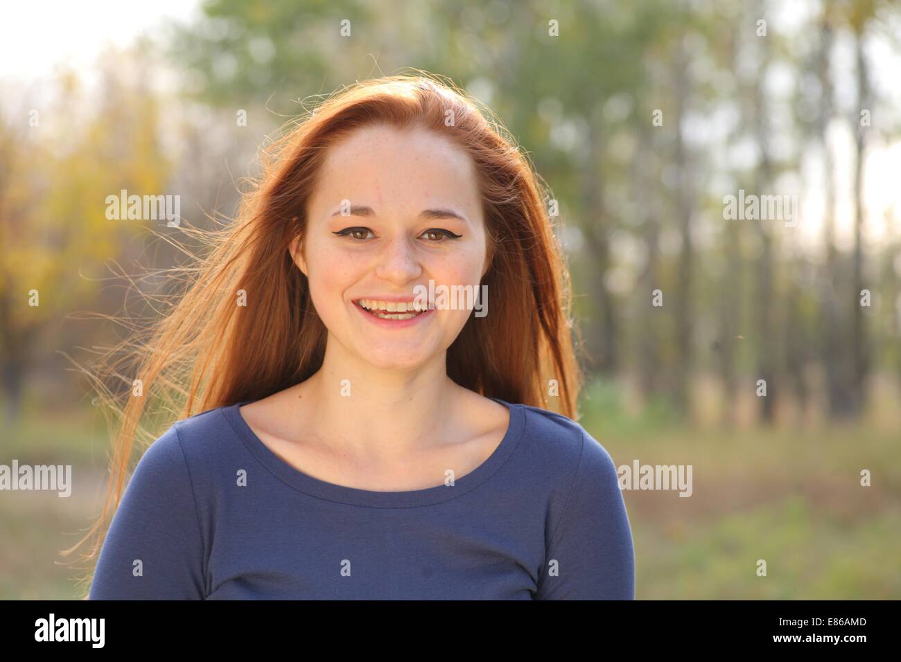 Young redhead woman in the park having fun Stock Photo - Alamy