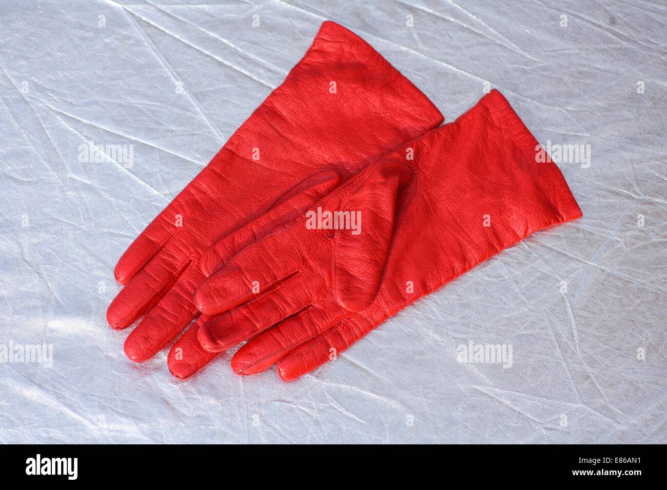 Red gloves isolated on silverbackground Stock Photo - Alamy