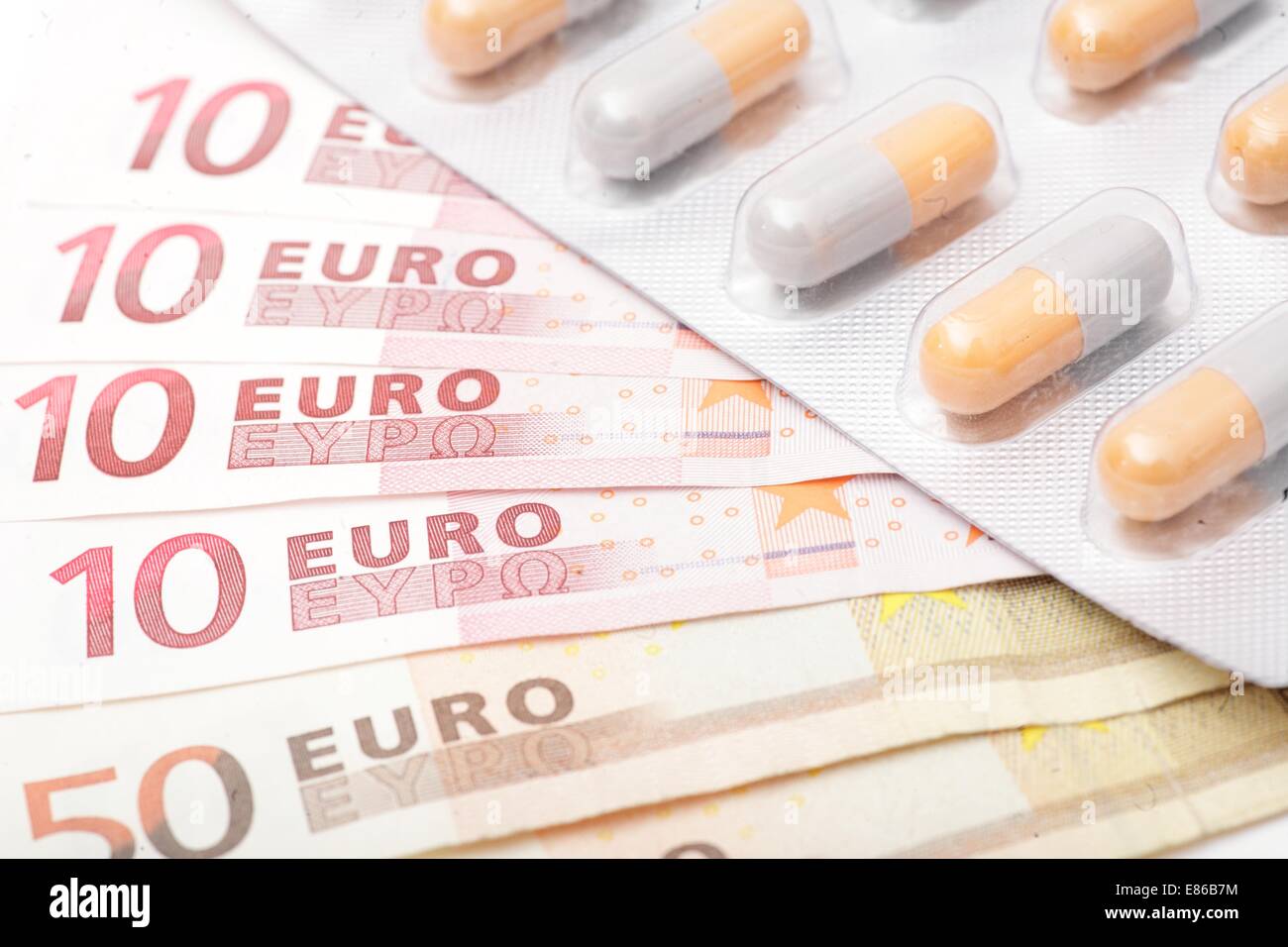 Medical red pills and money close up Stock Photo - Alamy