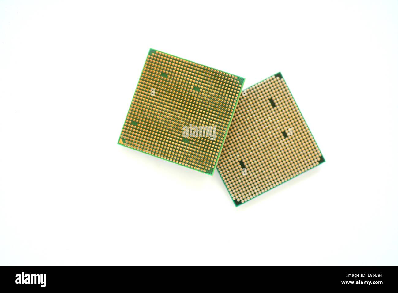 Closeup of a computer processor with golden pins over a white ...