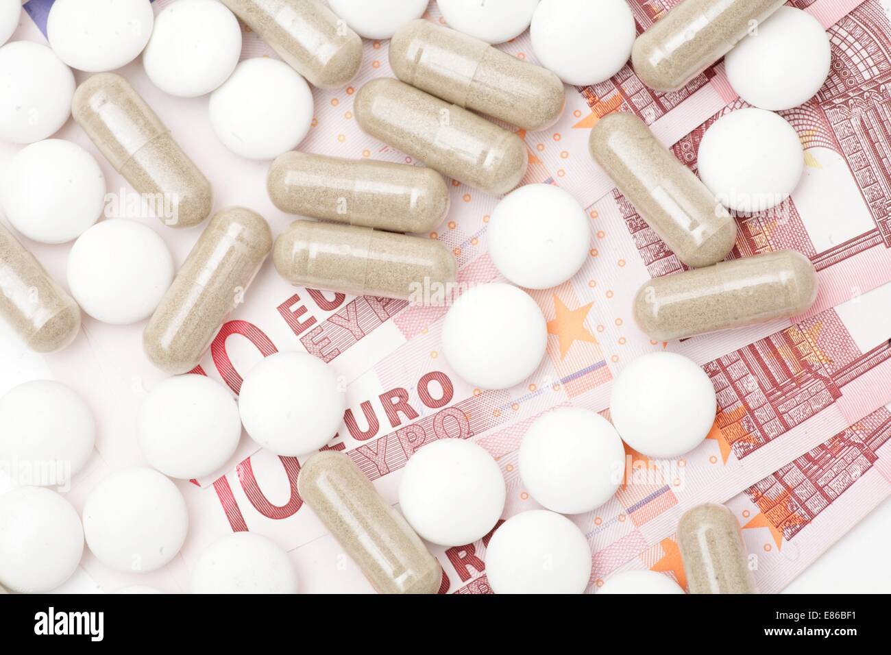Medical red pills and money close up Stock Photo - Alamy