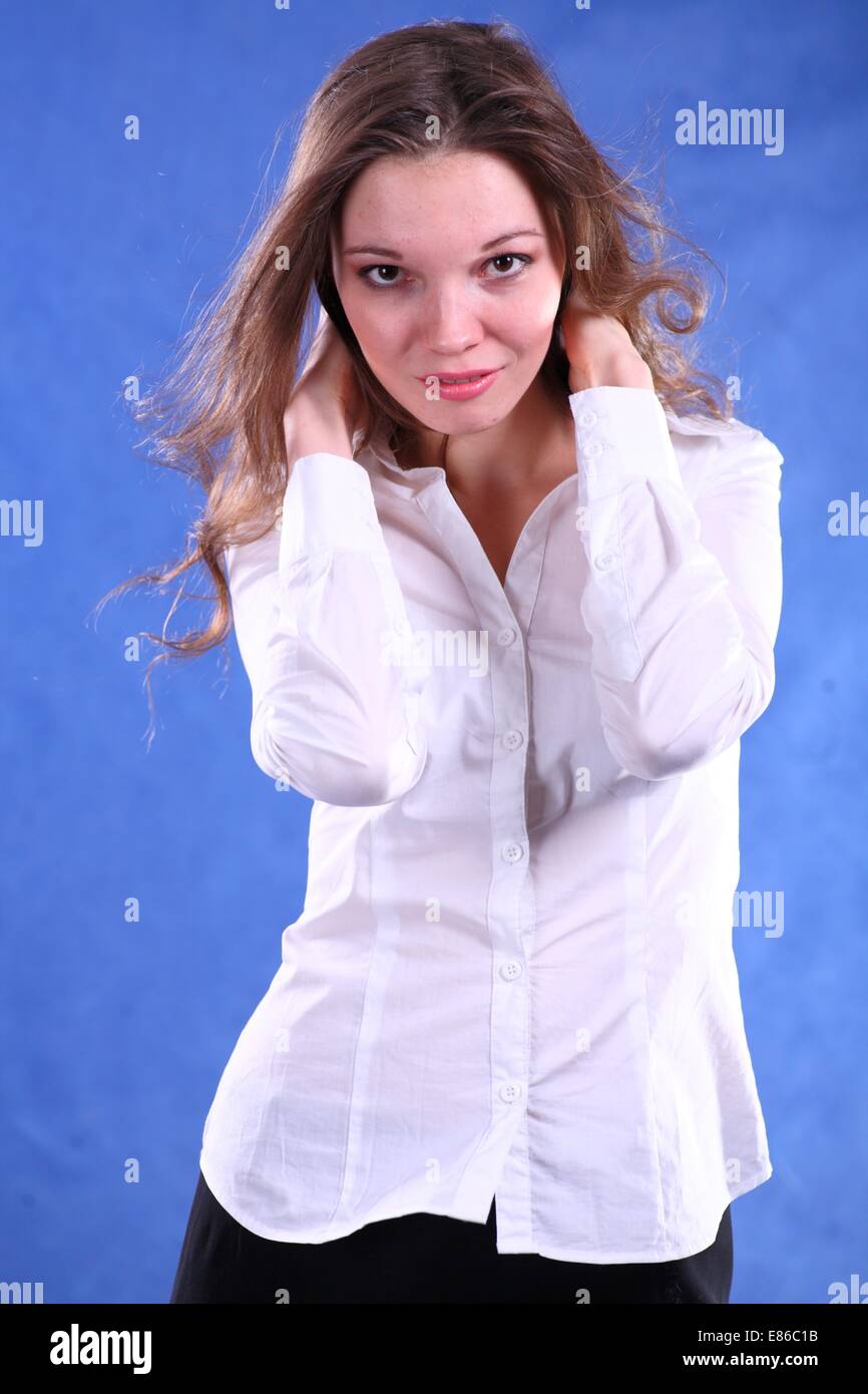 Intelligent looking female. This picture is taken in a studio on blue ...