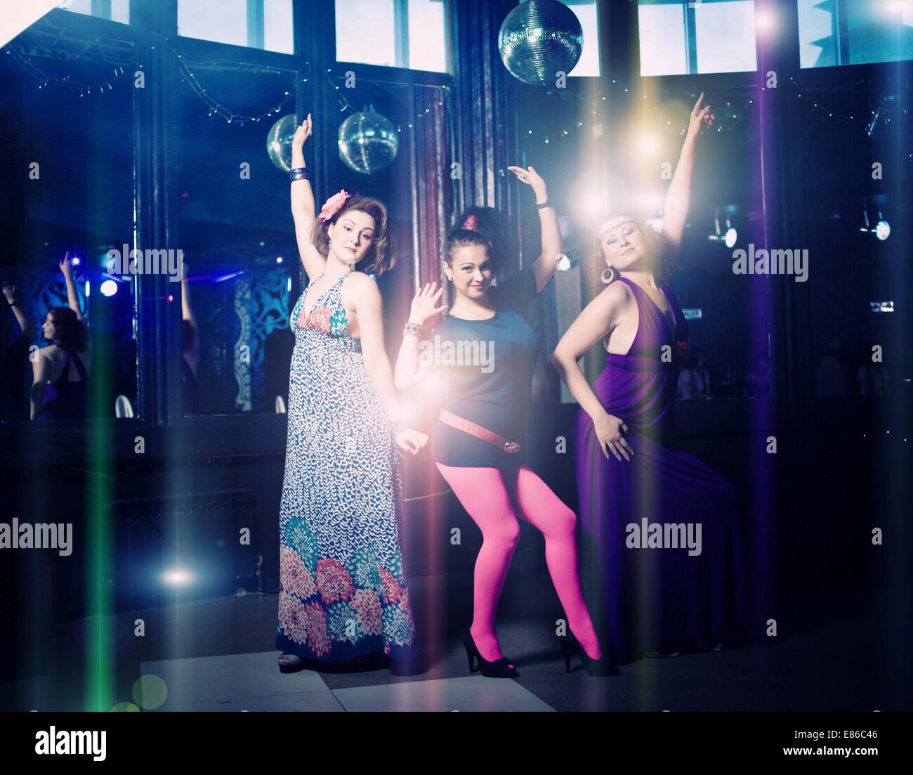 Three glamorous girls having fun at disco in night club Stock Photo - Alamy