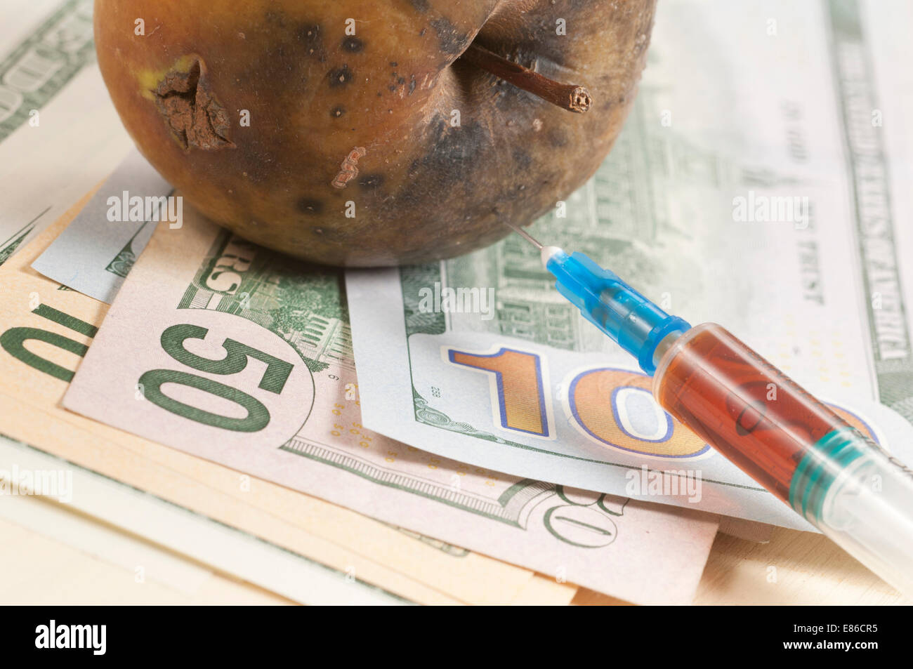 Dead apple with syringe on dollars - concept "Narcotic drugs kill Stock ...