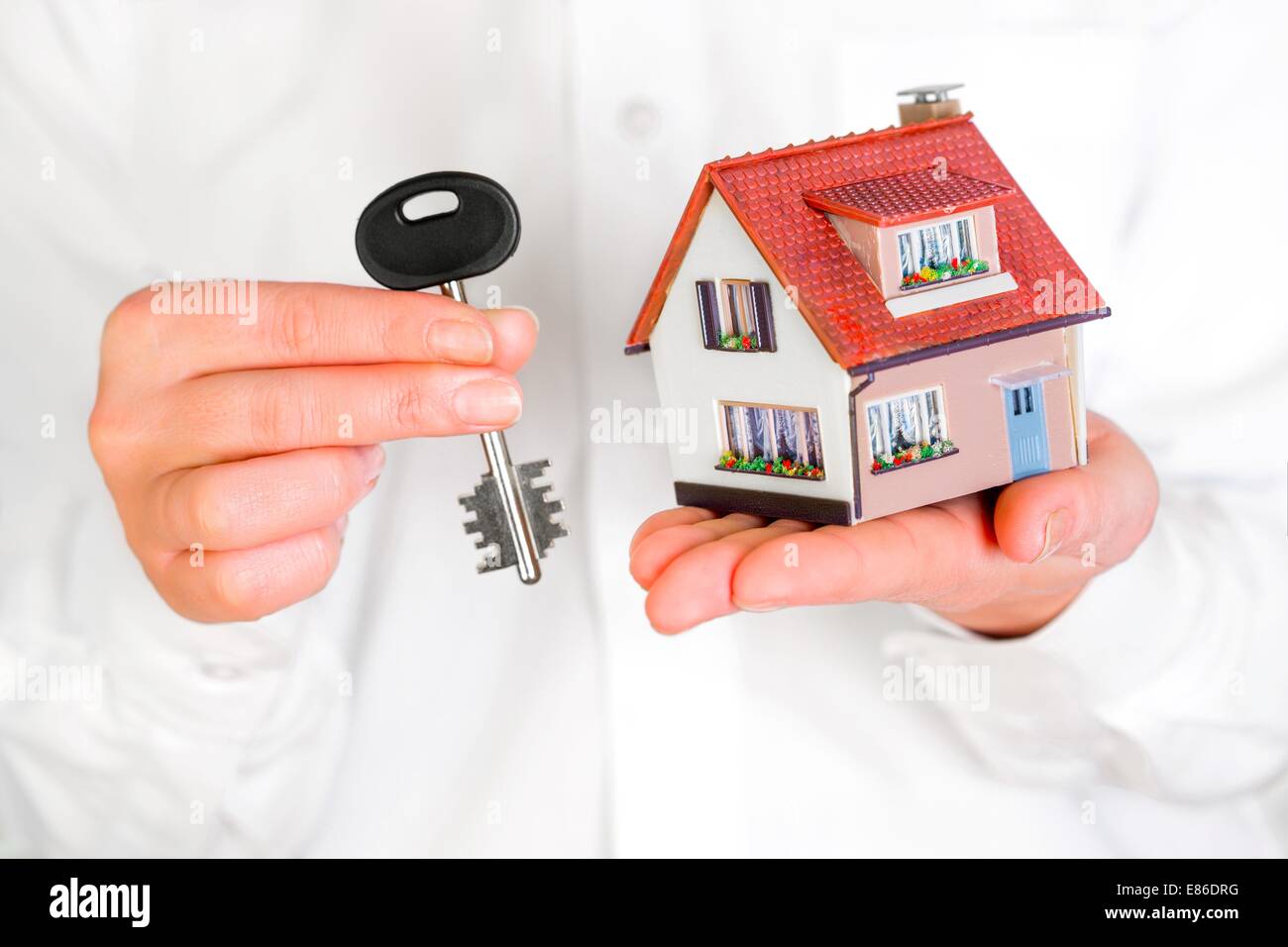 house in human hands on a white background Stock Photo - Alamy