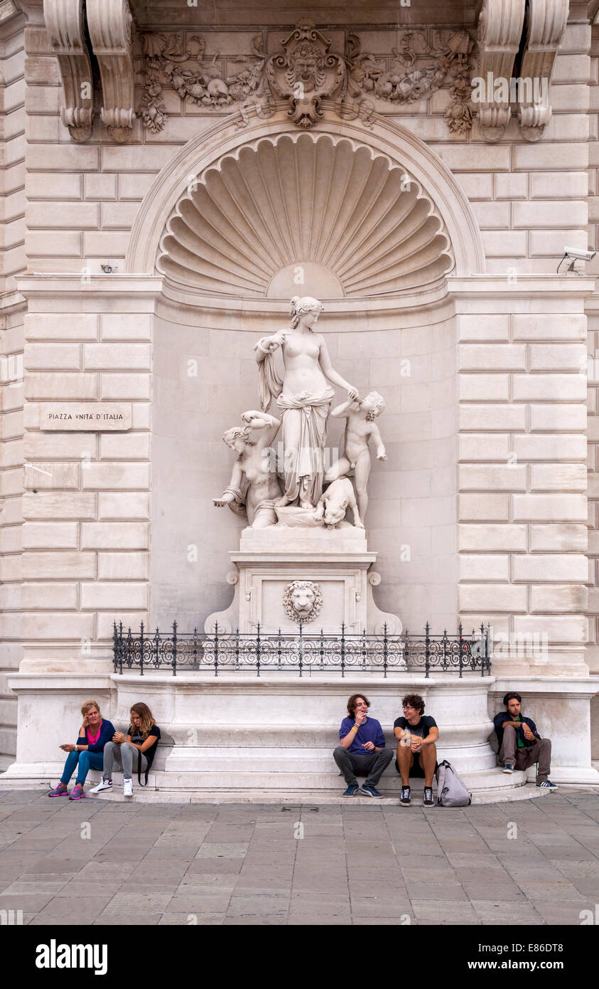 Young Italians by statue in Piazza Unita D'Italia in Trieste Italy ...