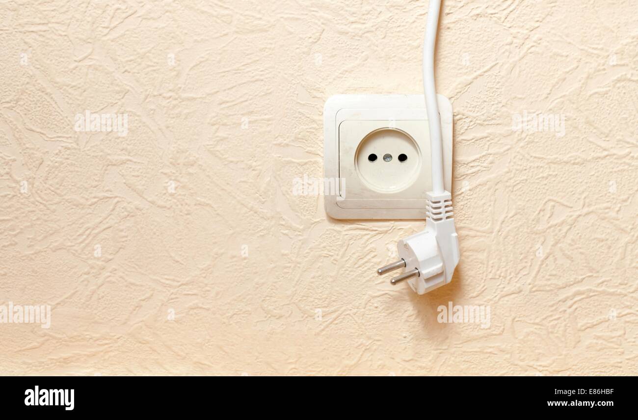 Electric wall plug at a beige wall Stock Photo - Alamy