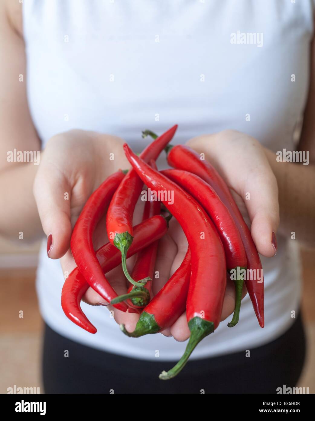 Chili Peppers In Hand Stock Photo - Alamy