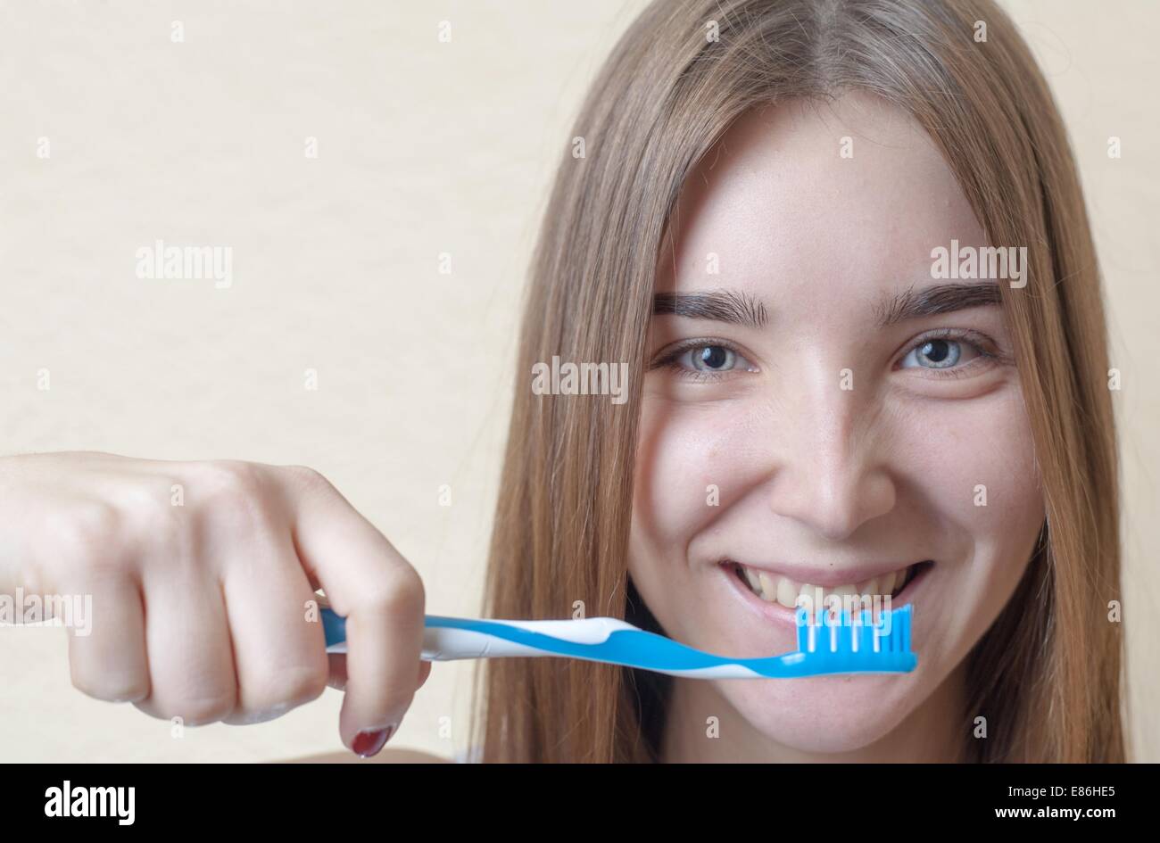 Closeup on woman's toothy smile brushing her teeth Stock Photo - Alamy