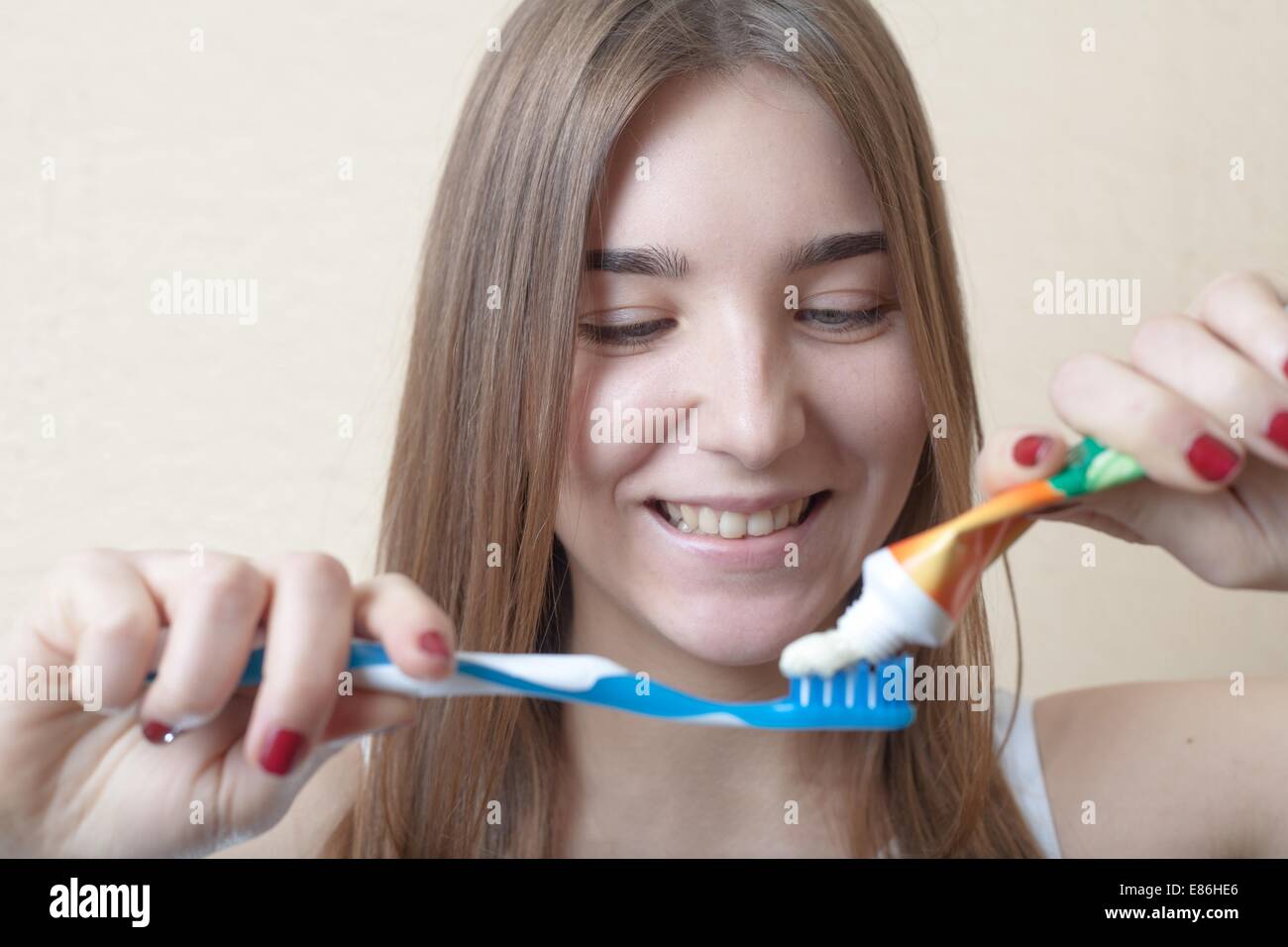 Closeup on woman's toothy smile brushing her teeth Stock Photo - Alamy