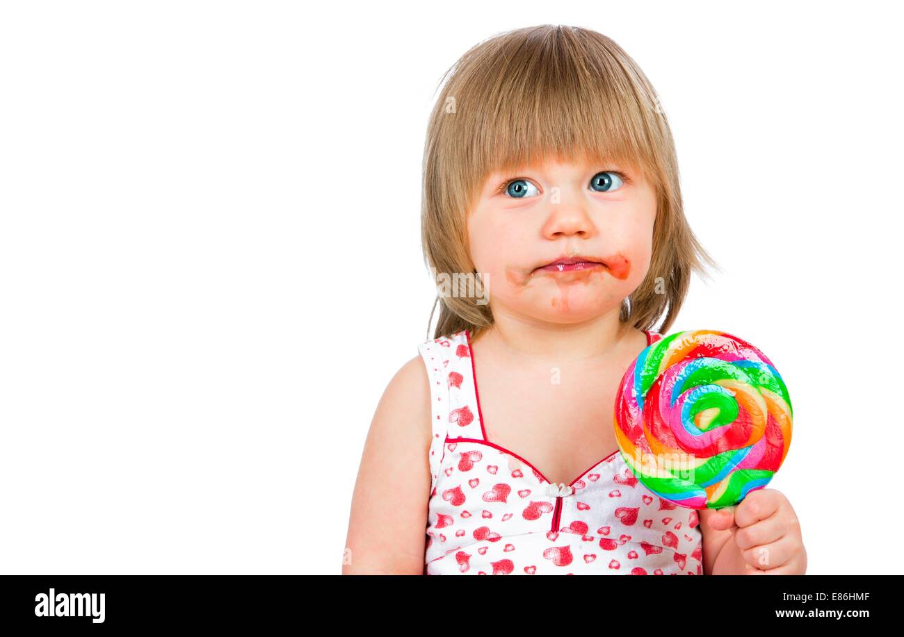 Baby girl eating a sticky lollipop on white background Stock Photo - Alamy