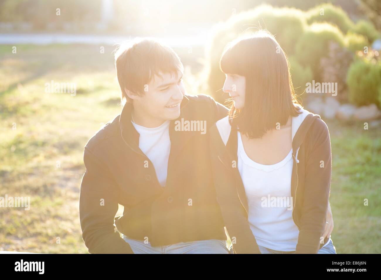 happy smiling couple against sun lite Stock Photo - Alamy