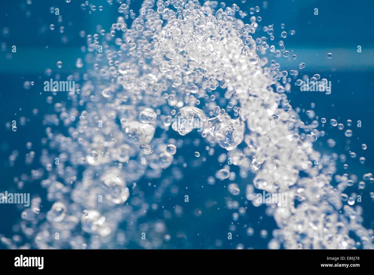 flow of water and water drop on blue Stock Photo - Alamy