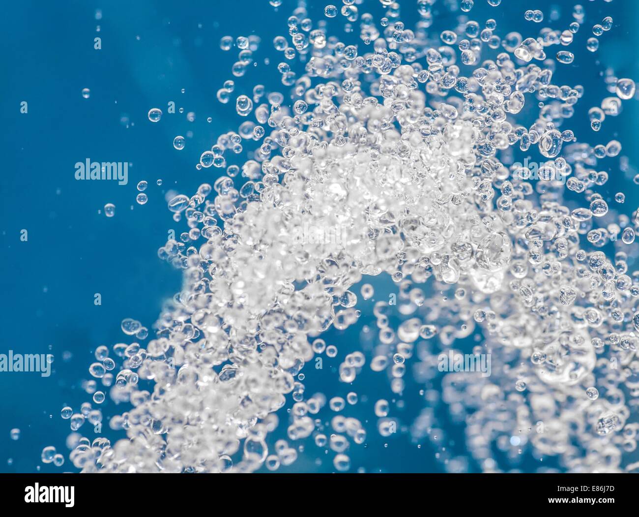 flow of water and water drop on blue Stock Photo - Alamy