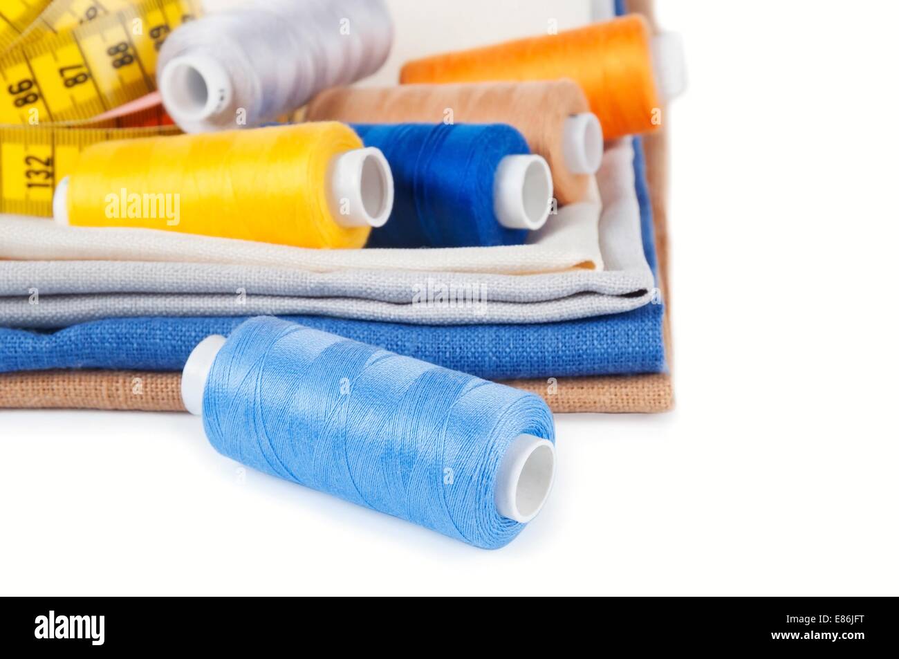 Spools of thread and cotton fabric on a white background Stock Photo ...