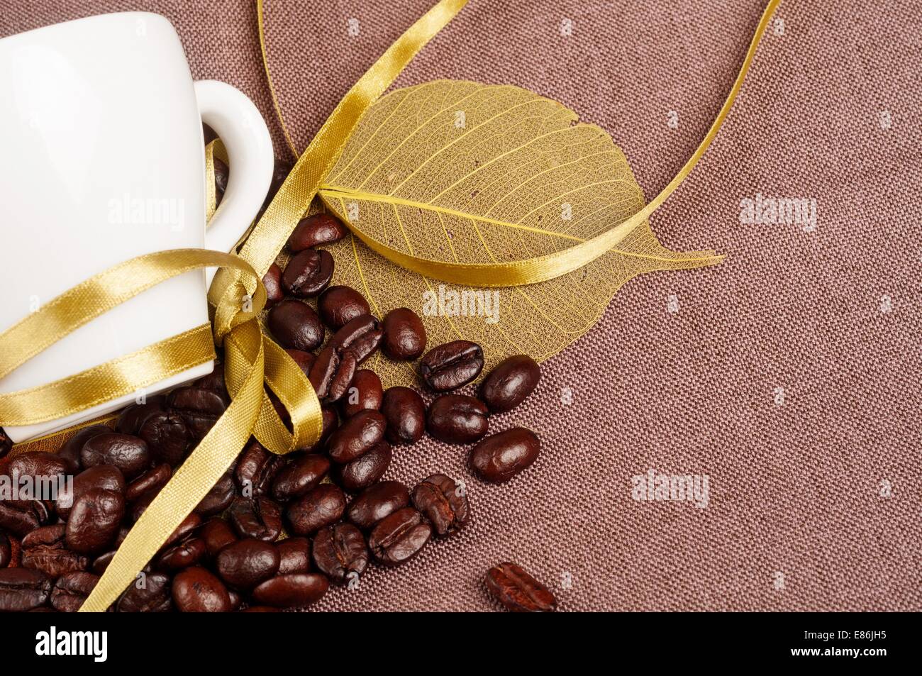 White coffee cup, yellow ribbon and coffee beans Stock Photo - Alamy